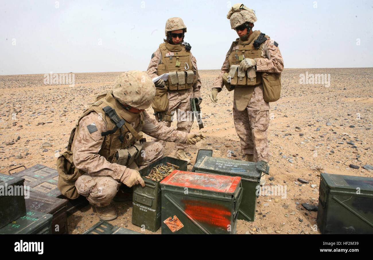 Lance Cpl. James E. Laflin rummages through a container filled with ...