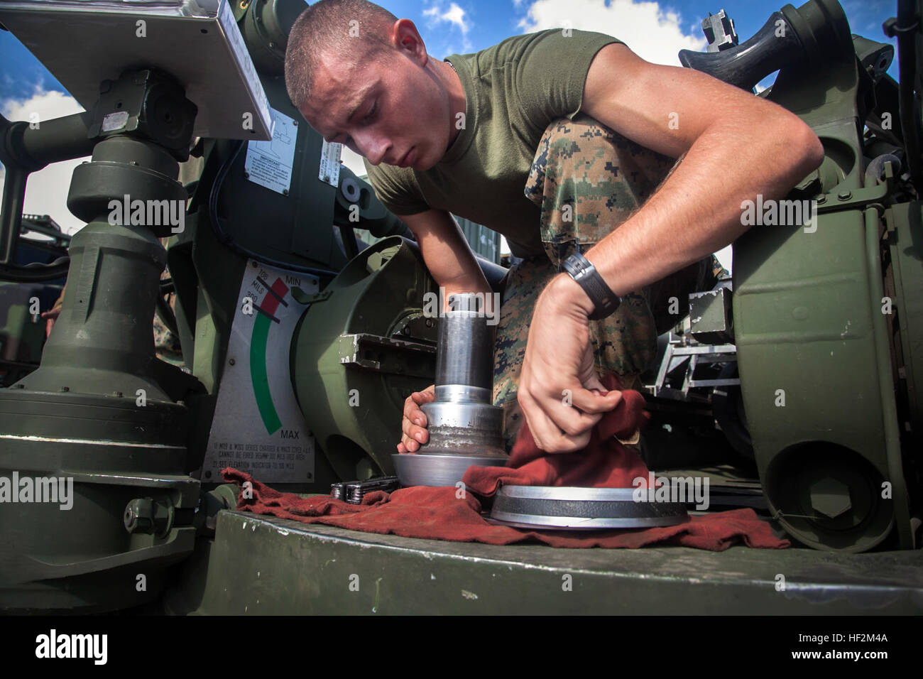 Lance Cpl. Johnathan Dowden, from Wichita Falls, cleans a spindle from ...