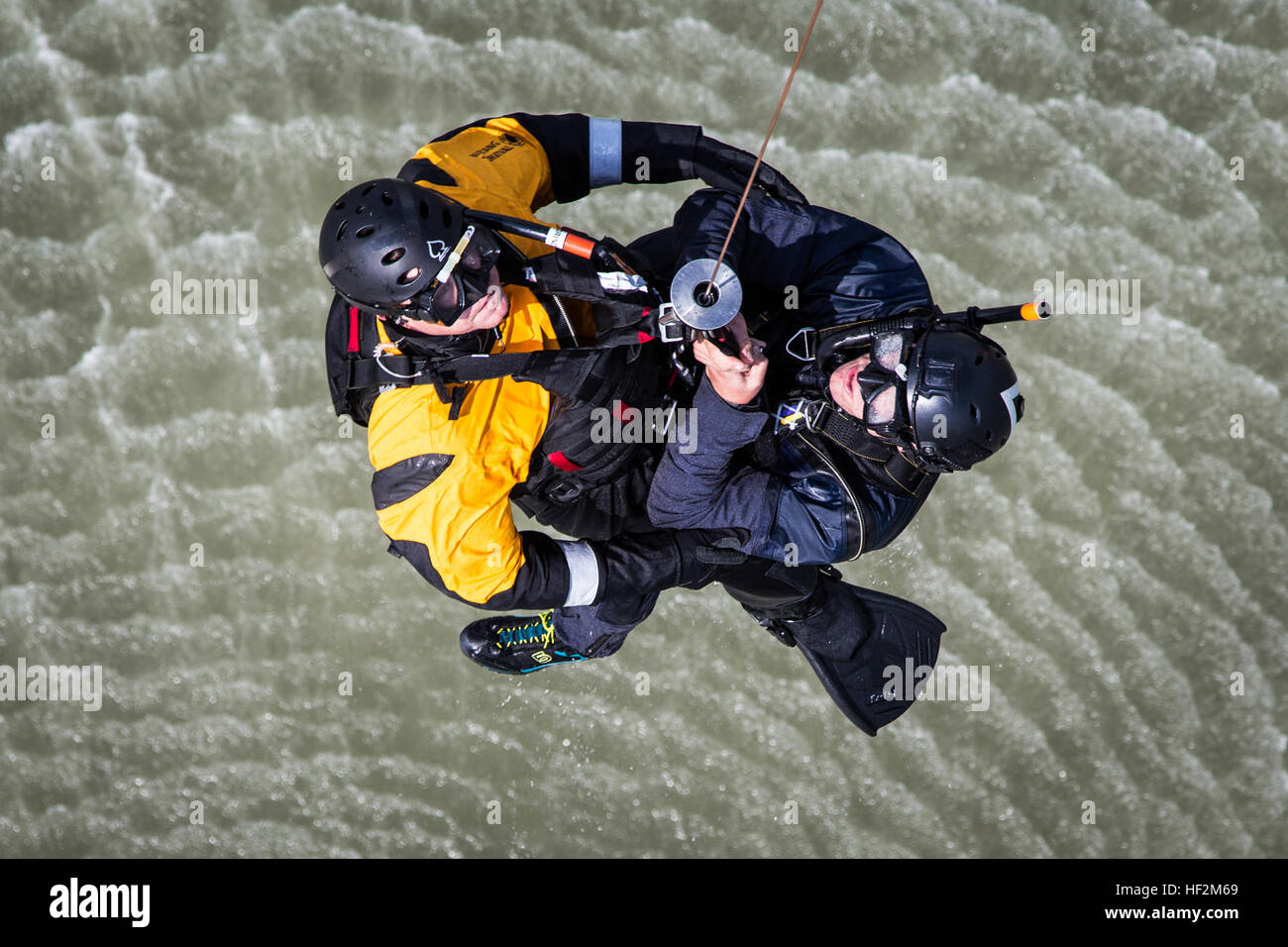 Jason Grindstaff (left) and Lynn Burttschell (right) are hoisted into a ...