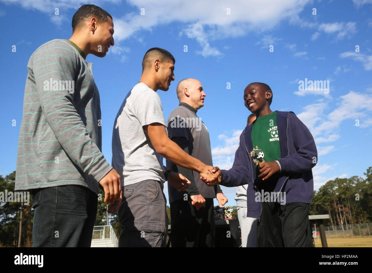 Roberto Ponce (center) coaches of team Fury shake hand out trophies and ...