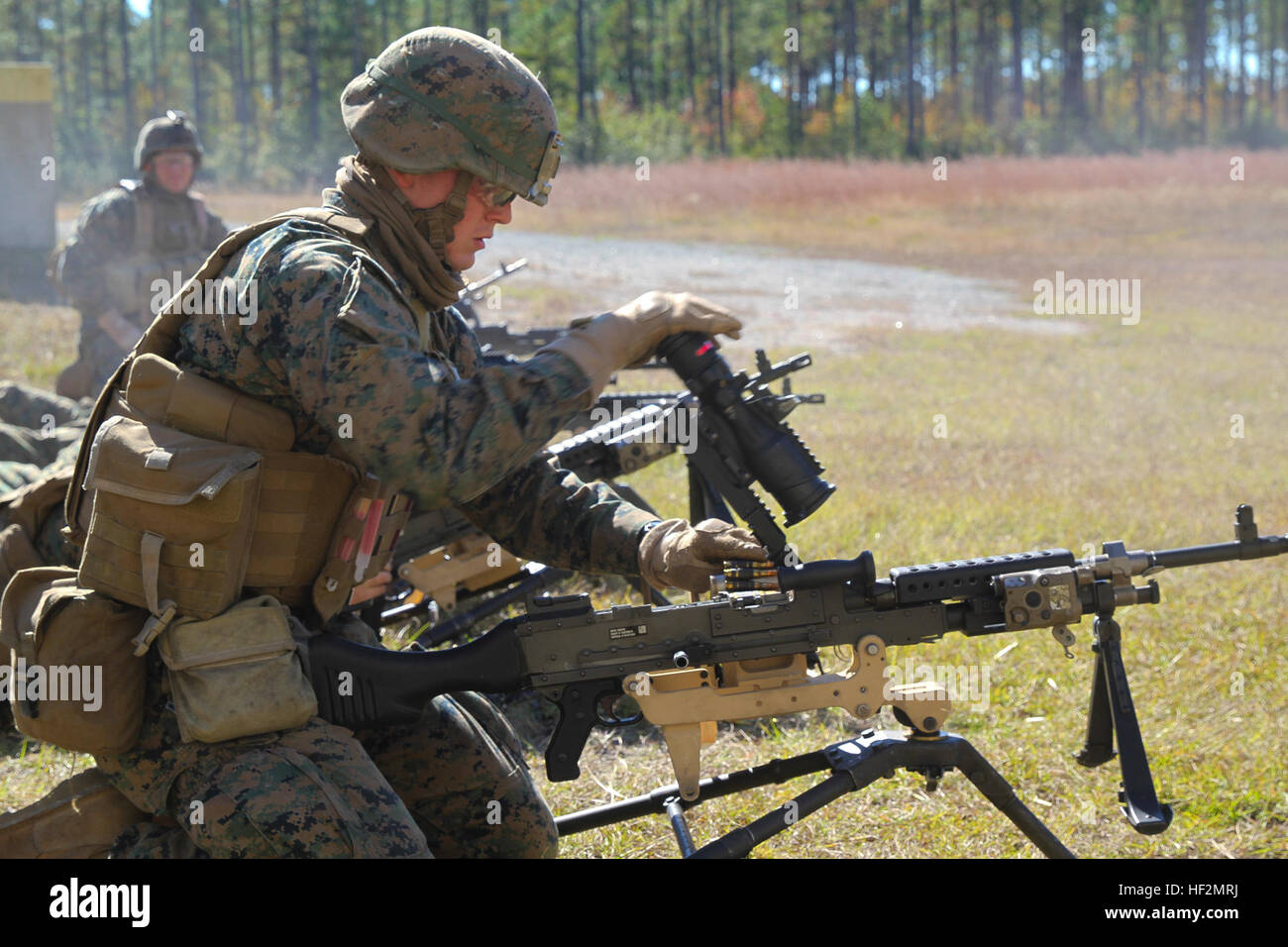 Bravo Company Marines load 7.62 mm ammunition into an M240B during a ...