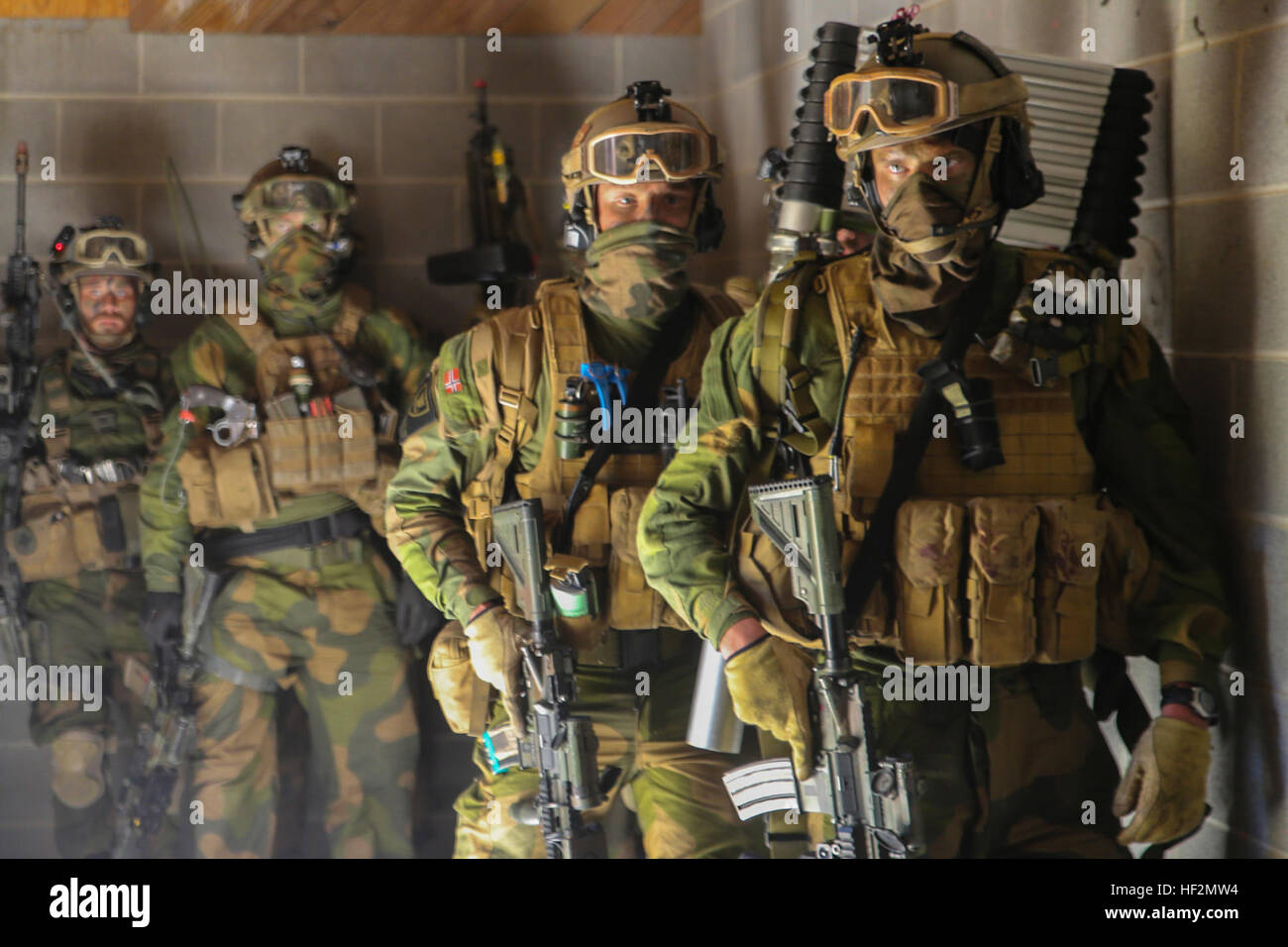 Soldiers with the Norwegian Telemark Battalion pause after clearing a ...