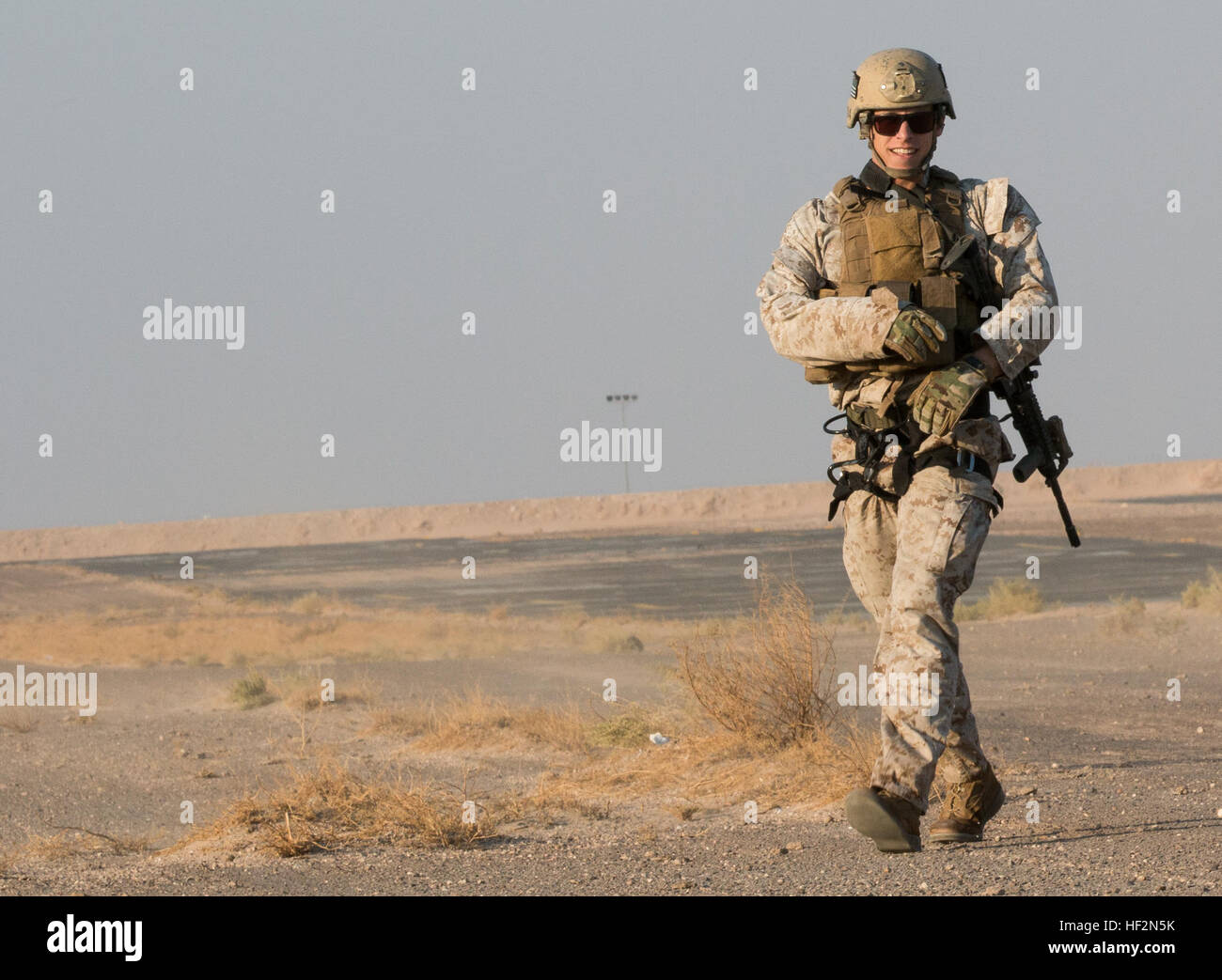 A U.S. Marine with the 11th Marine Expeditionary Unit walks toward ...