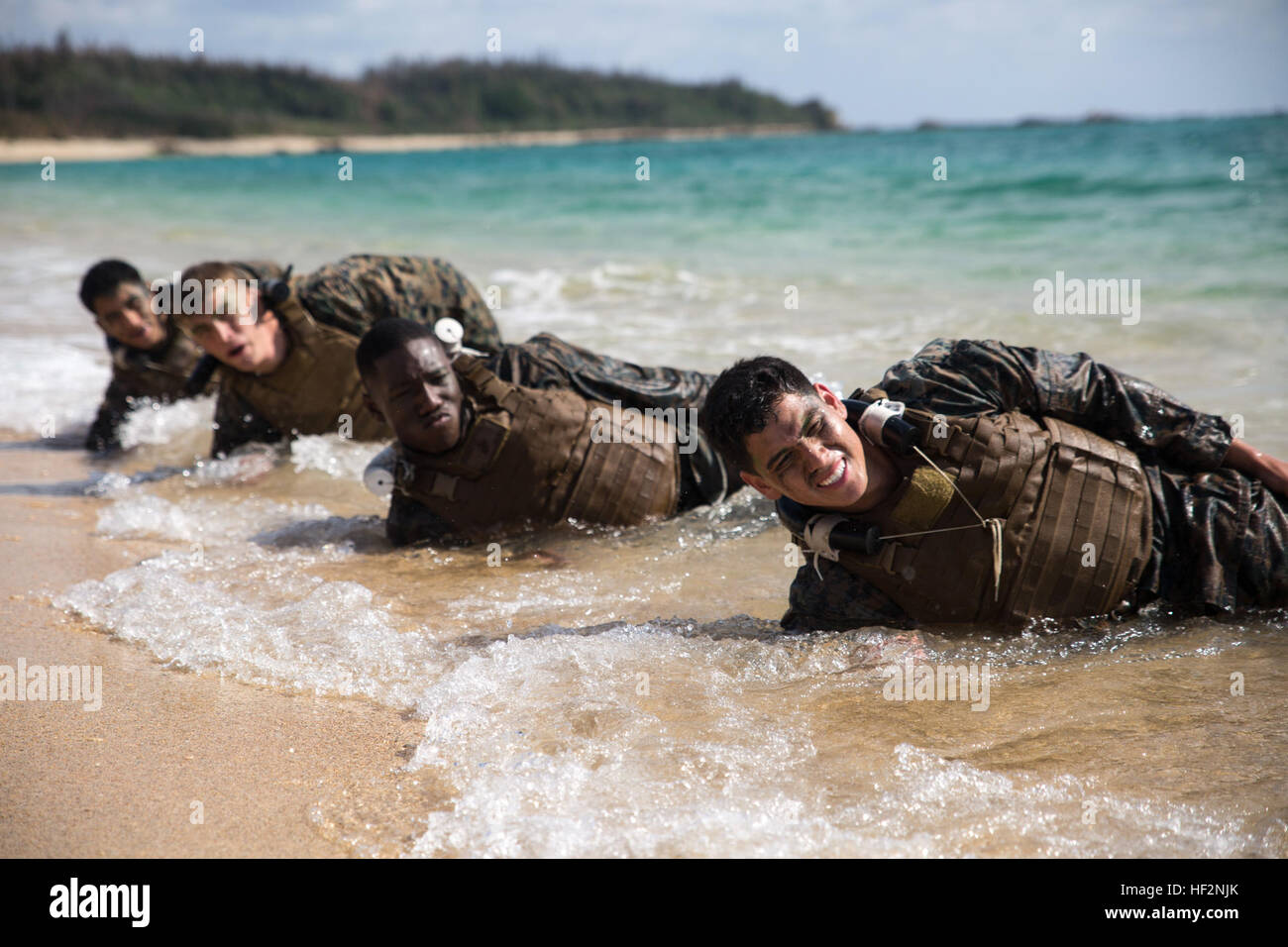 Marines perform a side plank in the shallow waters of Kin Blue, Okinawa ...