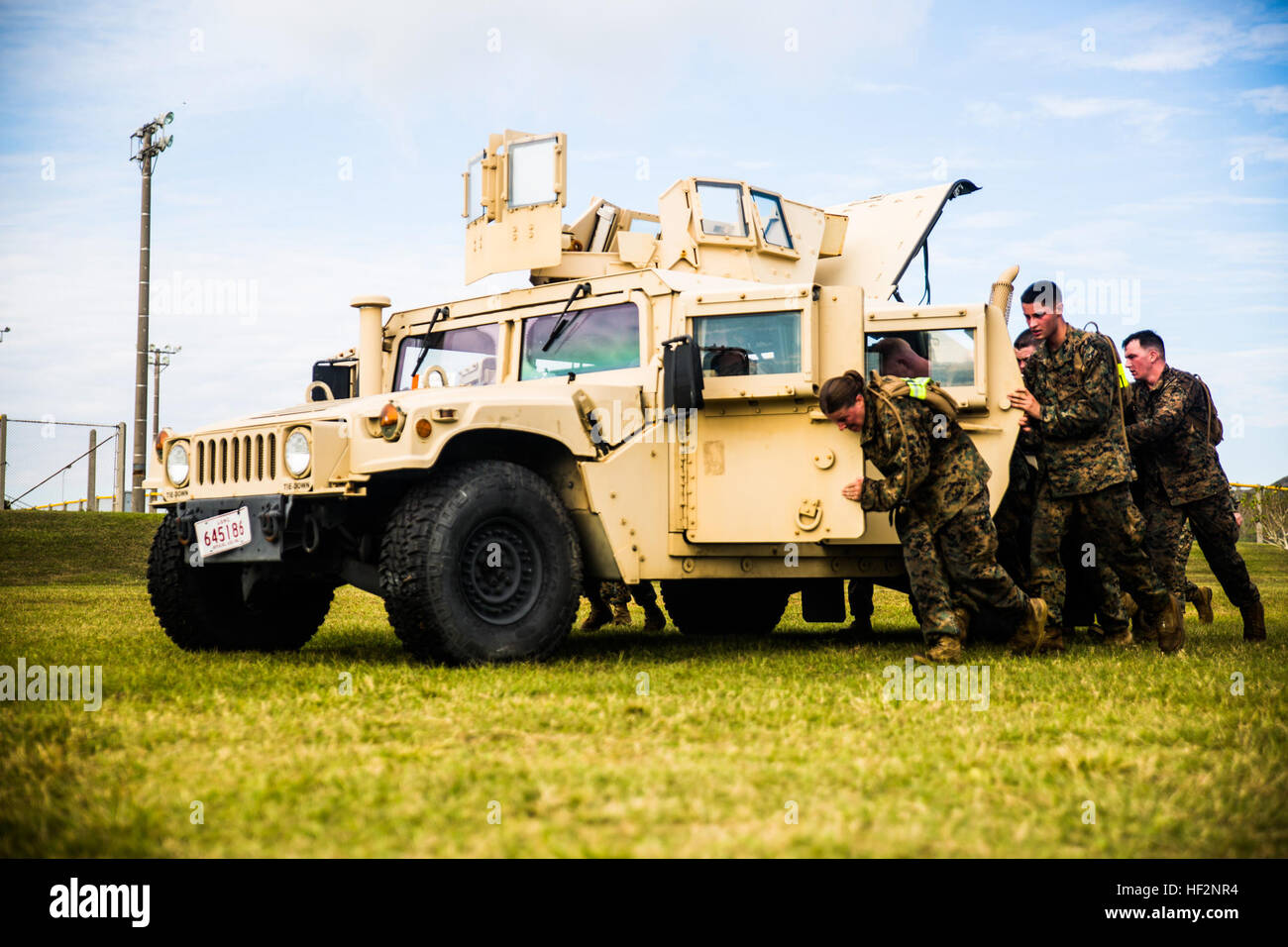 Marines push a Humvee during a squad competition Nov. 26 at Camp Hansen ...