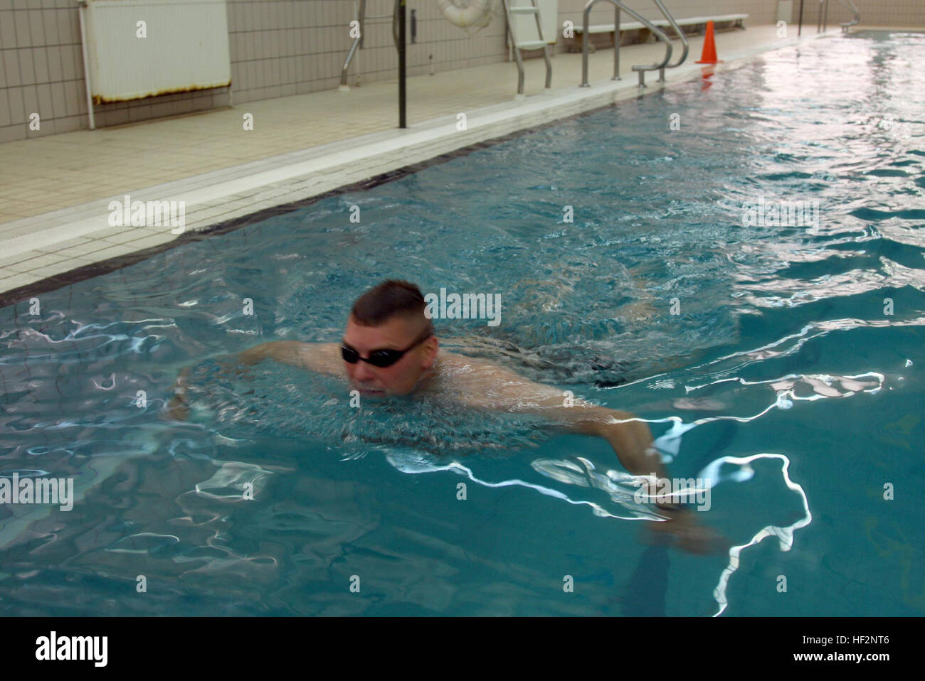 A Marine from 1st Reconnaissance Battalion swims before a water polo ...