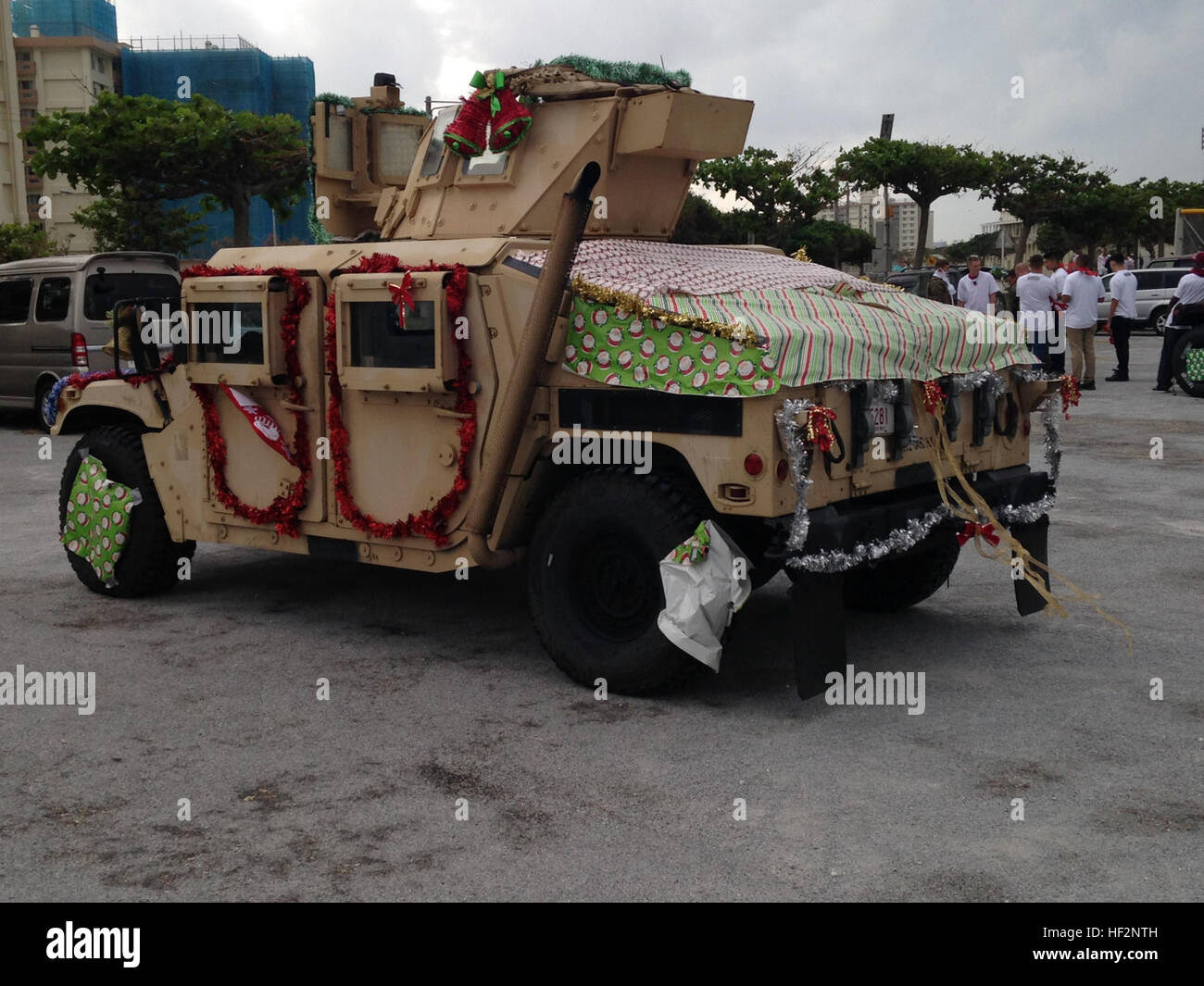 A Humvee is decorated as a float with Christmas ornaments and stockings ...