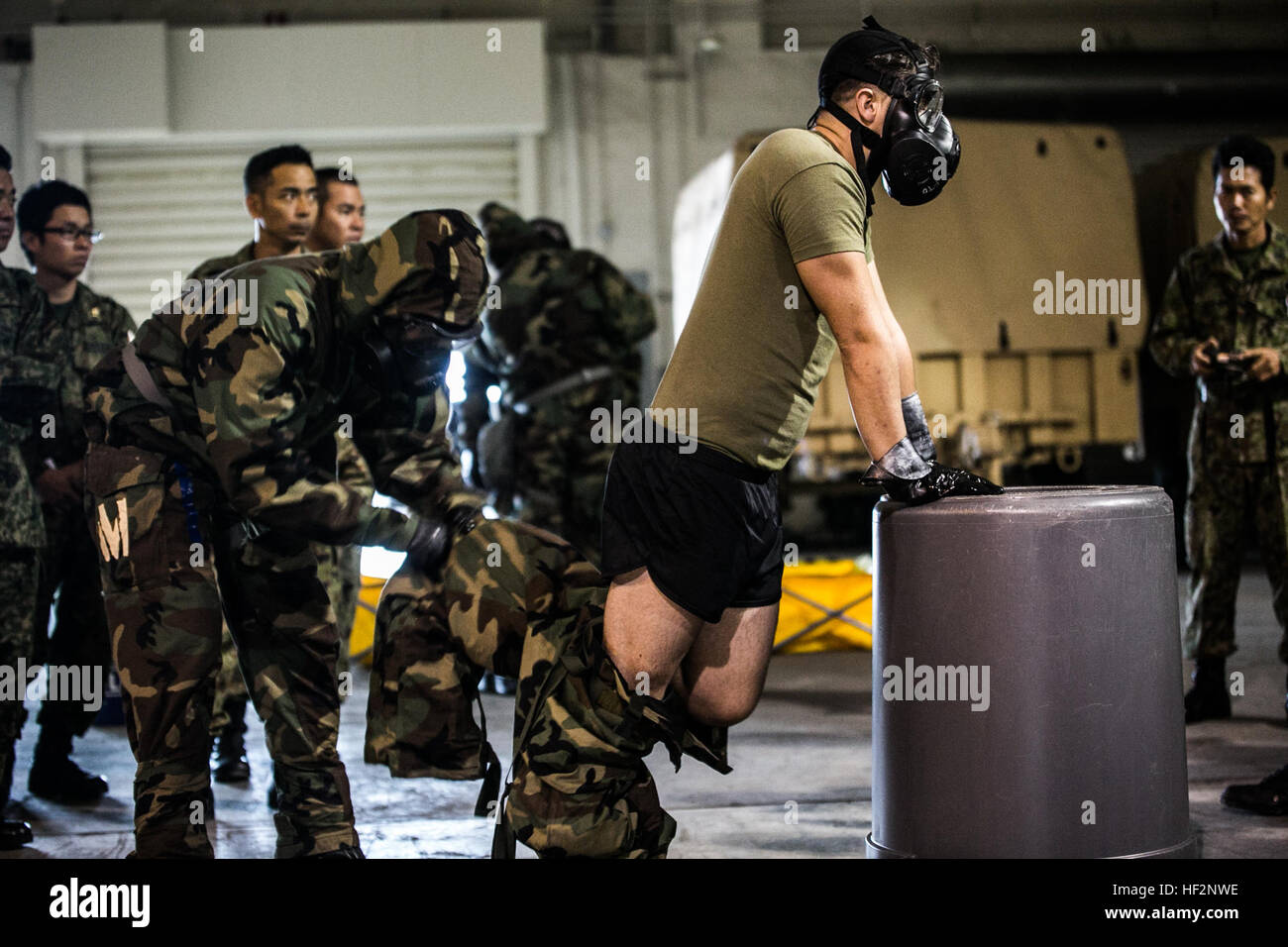 Lance Cpl. Benjamin L. Packer, right, removes his mission oriented ...