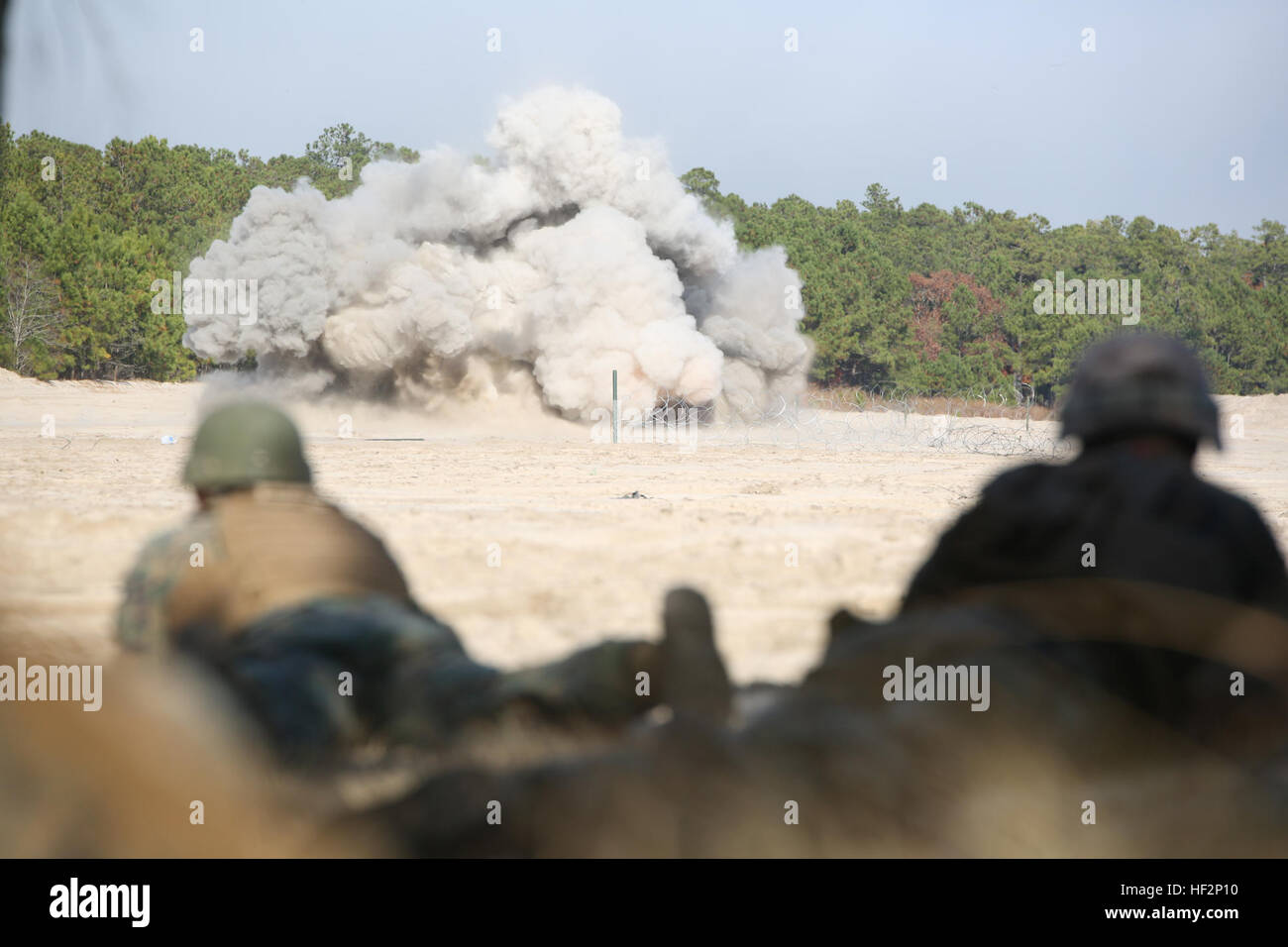 Position safety officers observe the detonation of an expedient line ...