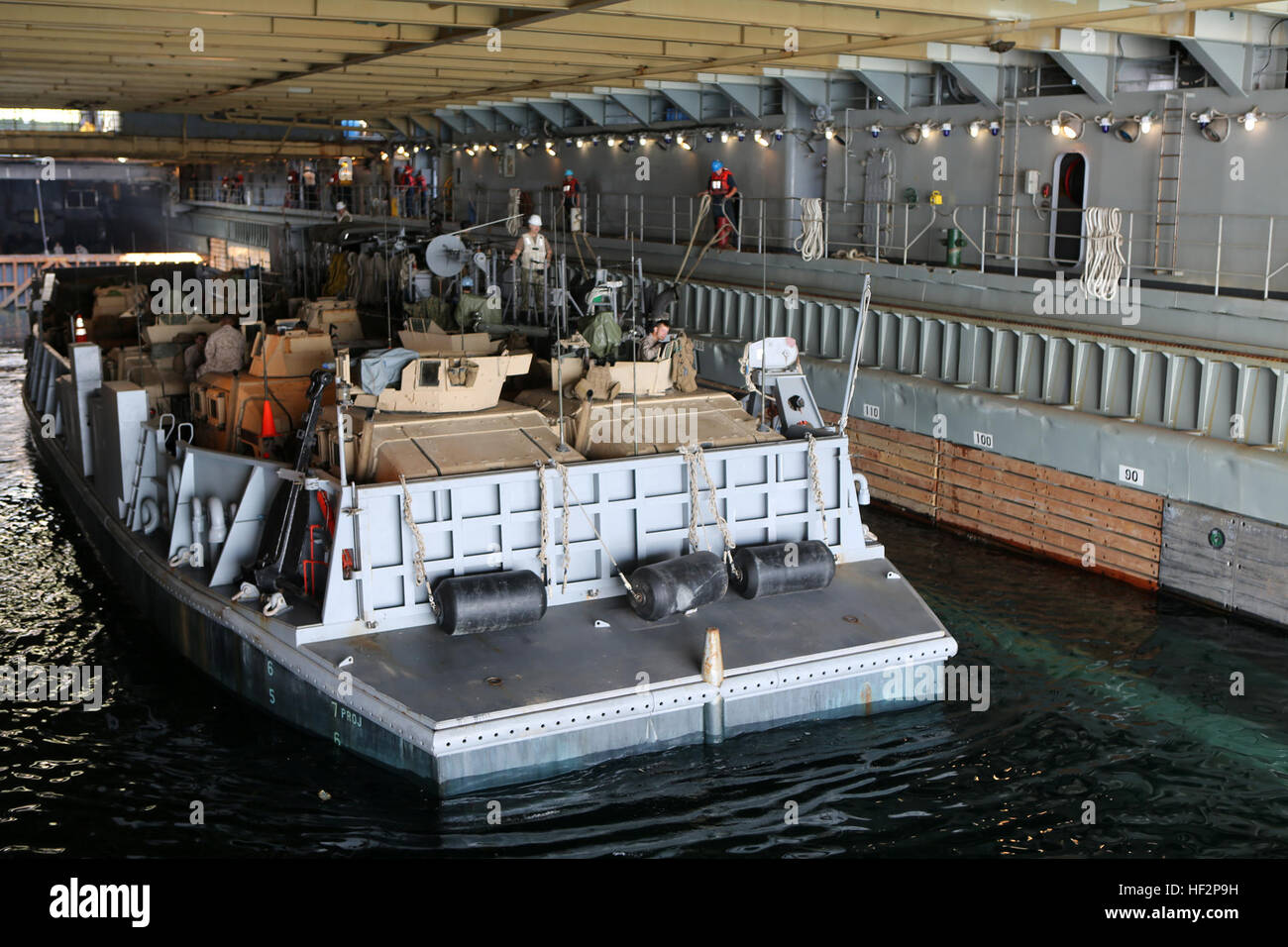 A landing craft utility (LCU) prepares to exit the well deck of the ...