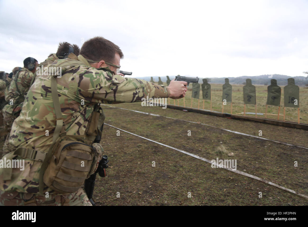 British Royal Marine Maj. Angus Precious aims downrange while ...