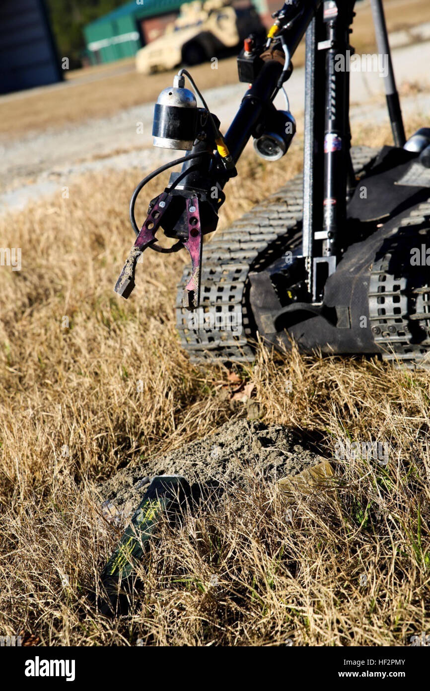 A Talon robot drops a block of C-4 on a simulated improvised explosive ...