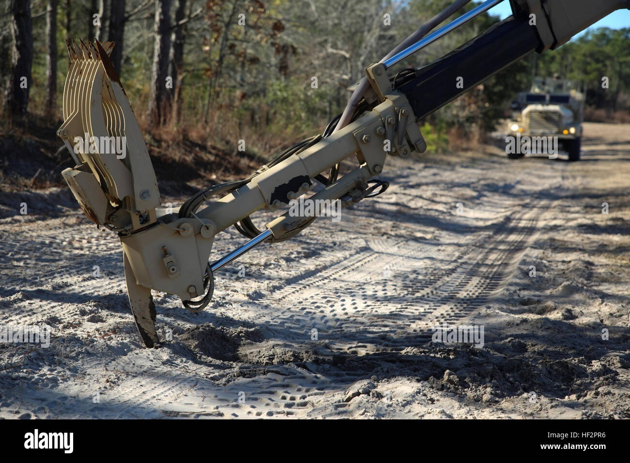 A Buffalo mine protected route clearance vehicle's arm digs in the ...
