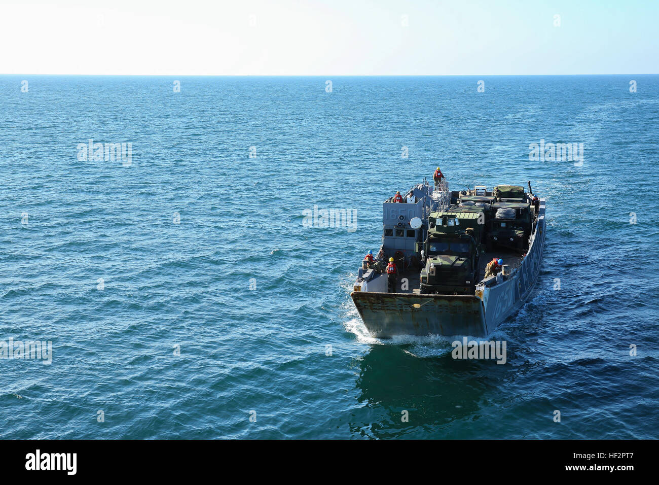 A Navy Landing Craft, Utility, or LCU, transports vehicles with the ...