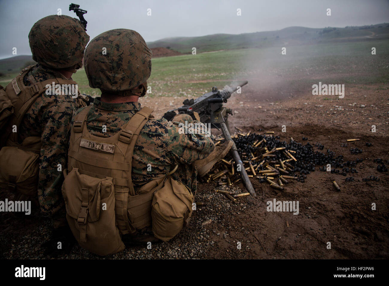 U.S. Marine Pfc. Jacob Piazza, right, fires a .50-caliber machine gun ...
