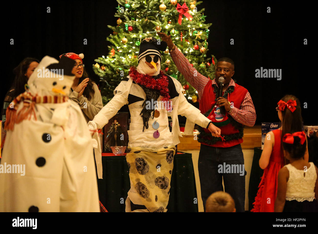 Marines, sailors and family members participate in a snowman-building ...