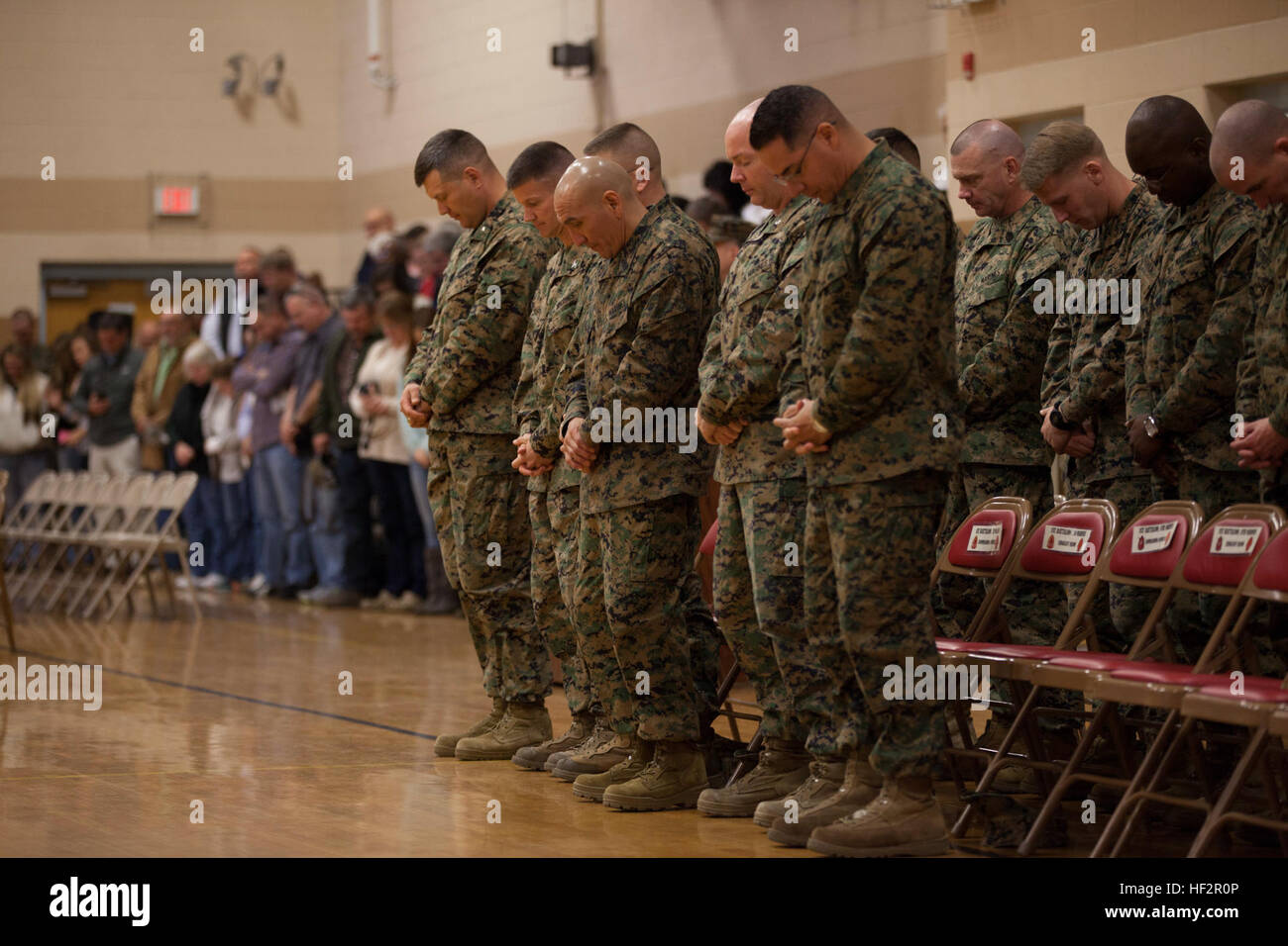 U.S. Marines with the School of Infantry East, bow their heads the ...