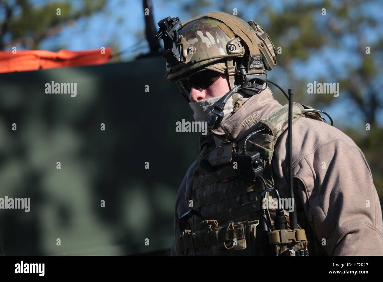 U.S. Air Force Senior Airman Ethan Hugg listens in on radio ...
