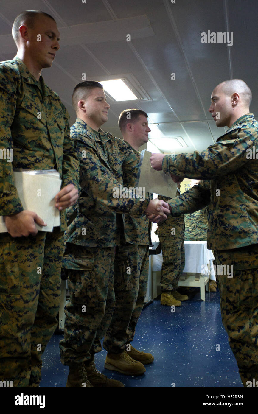 Sergeant David Blum, left, hands a diploma to a graduate of a Lance ...