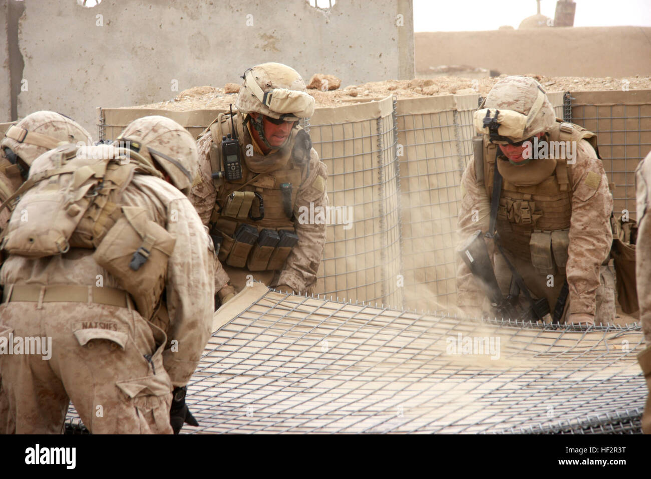 Marines from 3rd Battalion, 8th Marine Regiment work together to lift a ...