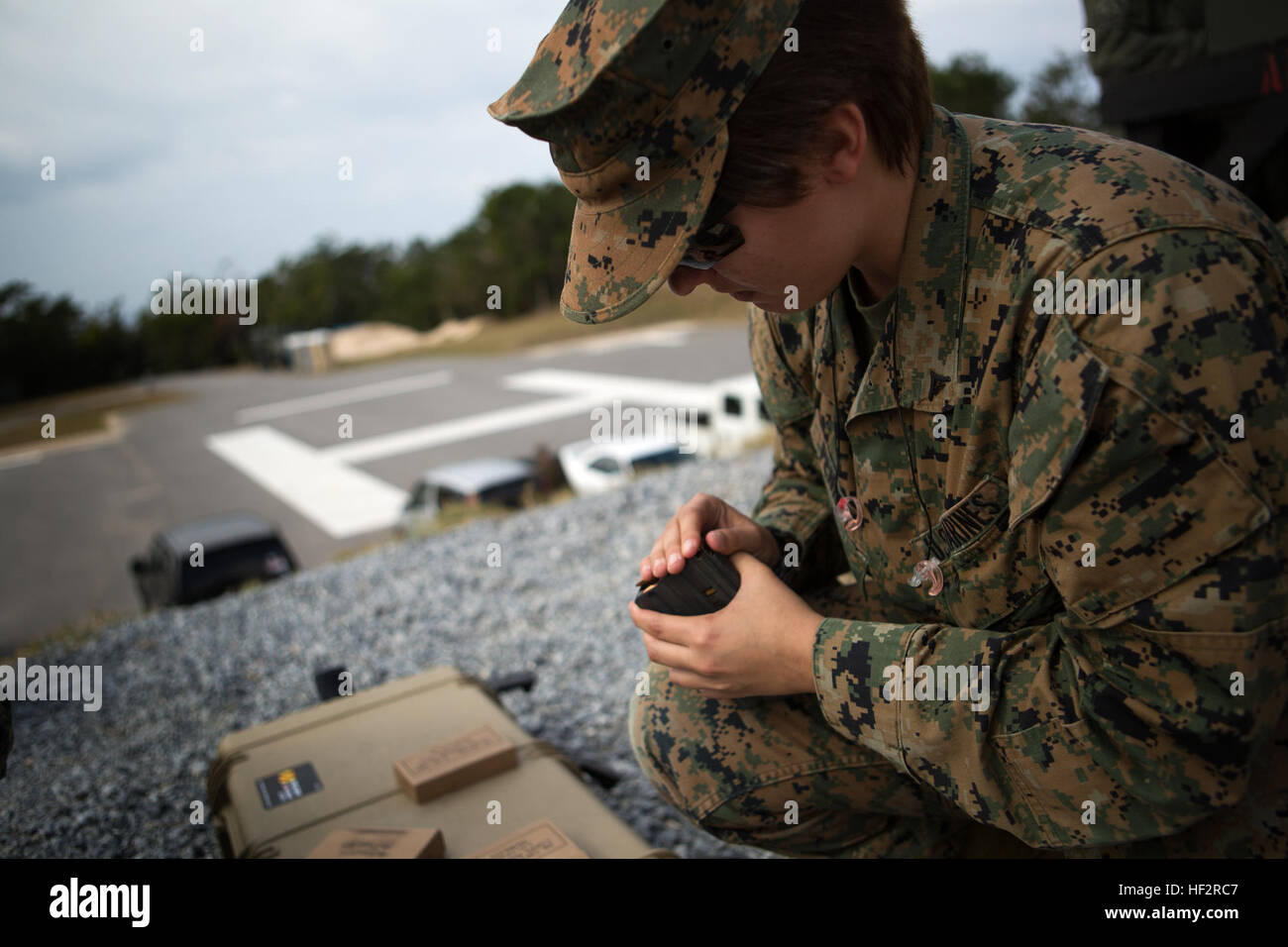 Lance Cpl. Jordan Penney loads 7.62 mm ammunition before firing an M110 ...