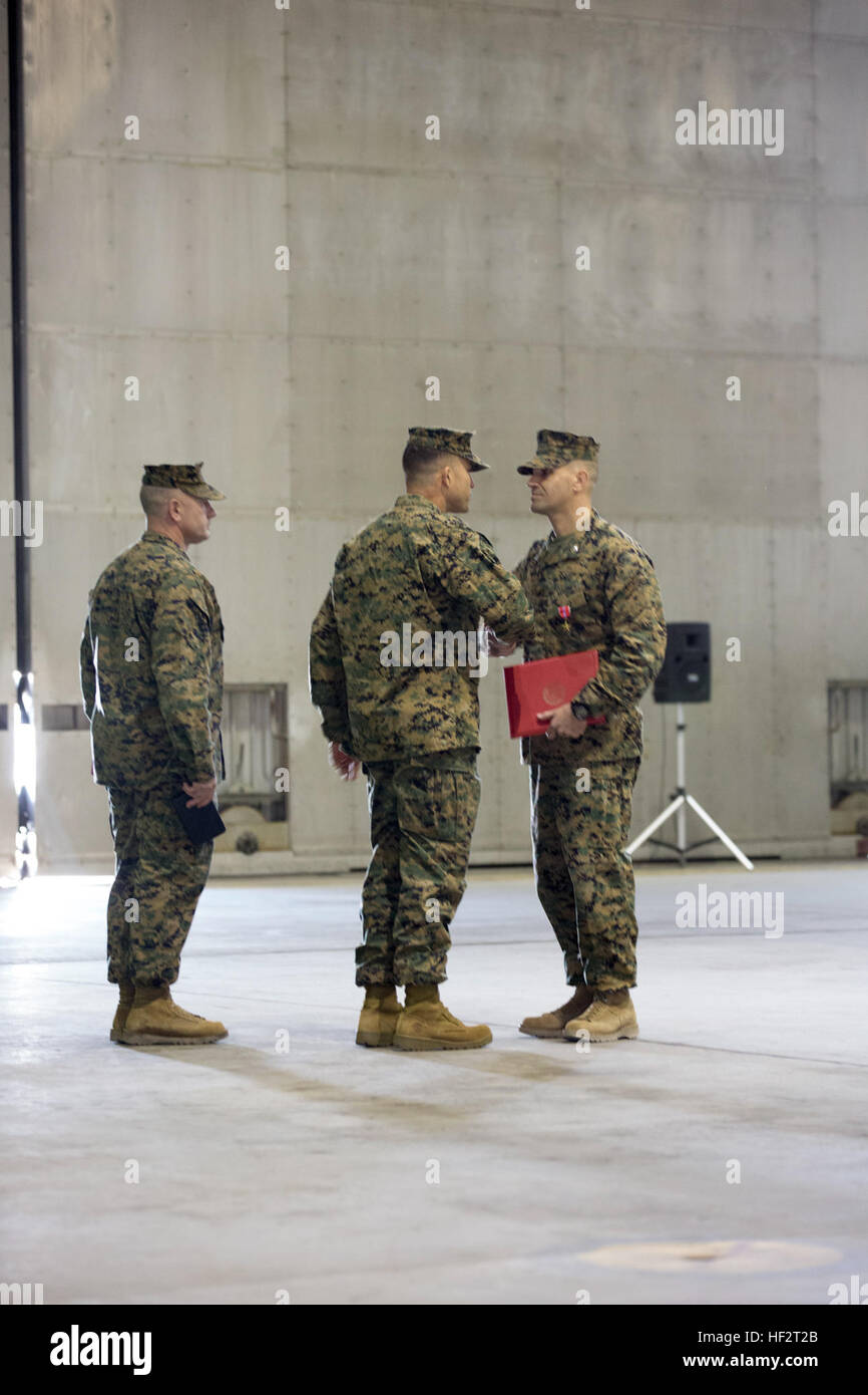 U.S. Marine Corps Col. James T. Jenkins, middle, presents a Bronze Star ...