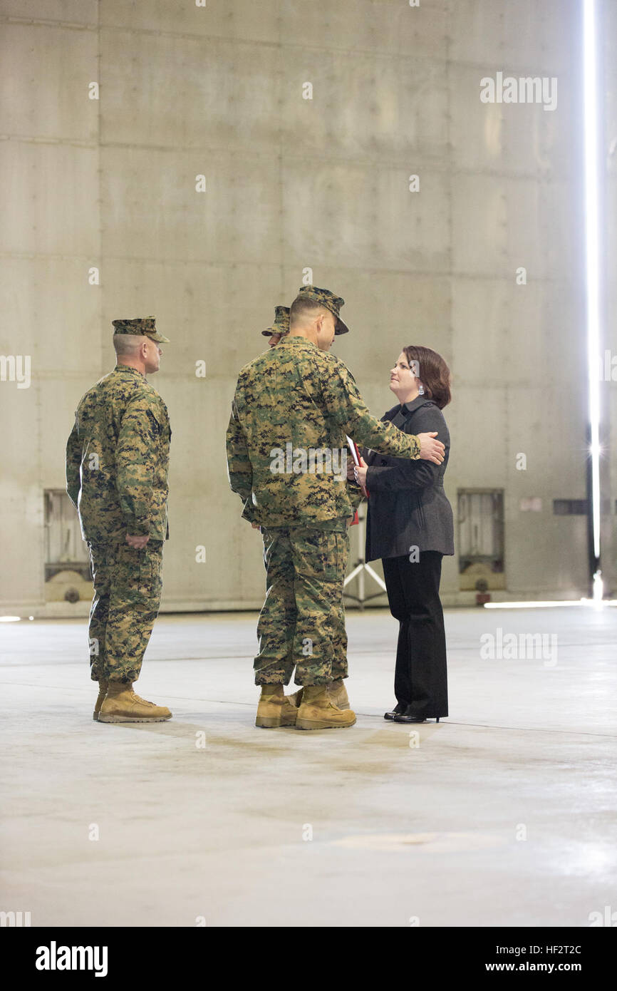 U.S. Marine Corps Col. James T. Jenkins, middle, presents a certificate ...