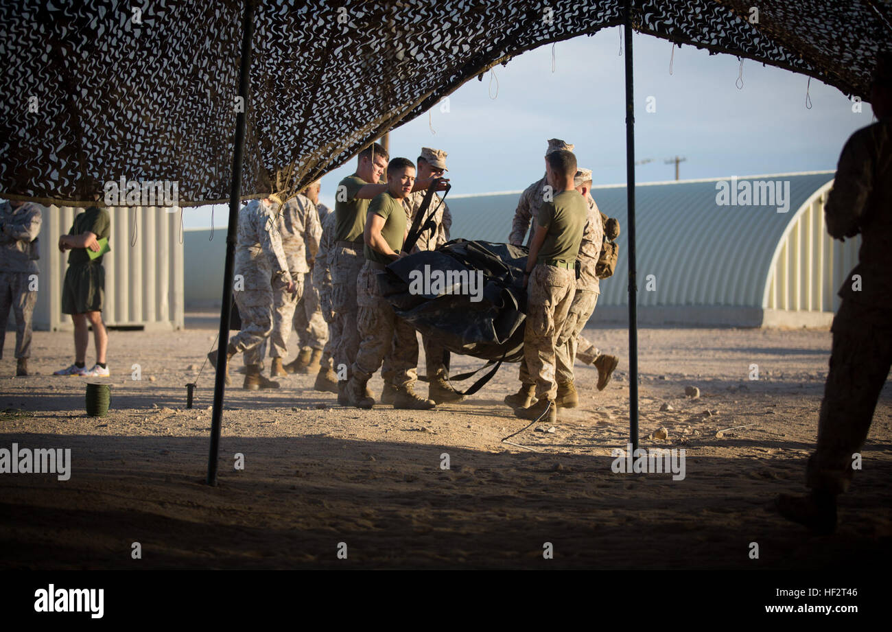 U.S. Marines assigned to 4th Marine Regiment bring in the tents that go ...