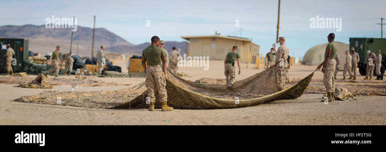 U.S. Marines assigned to 4th Marine Regiment lay out cammie netting ...