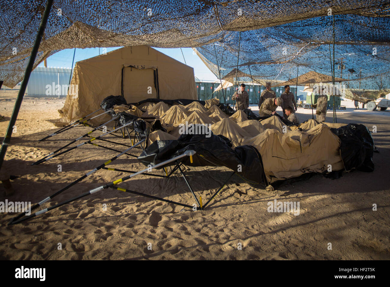 U.S. Marines assigned to 4th Marine Regiment unfold tents during the ...