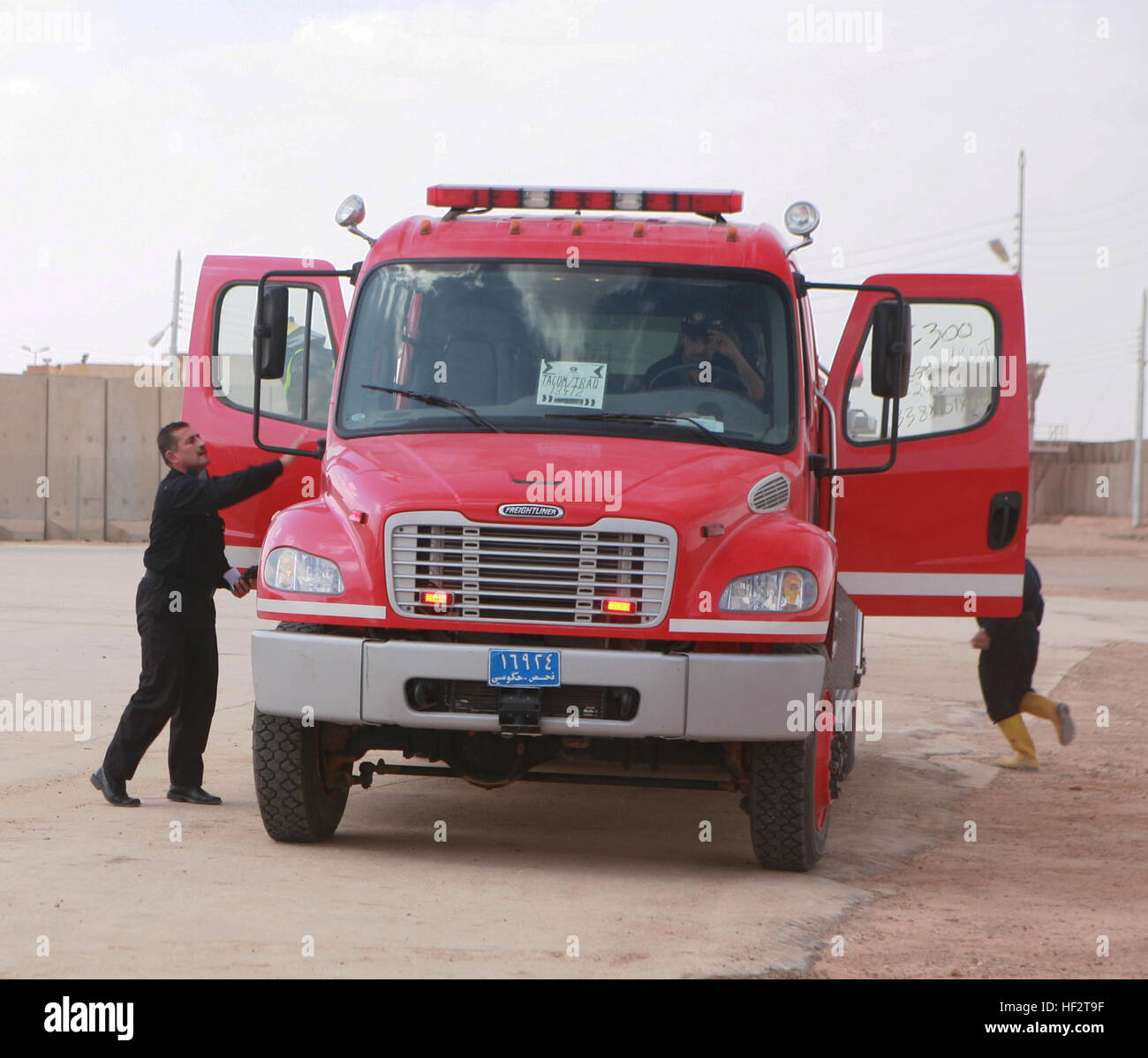 Iraqi firefighters respond to a simulated fire during a validation ...