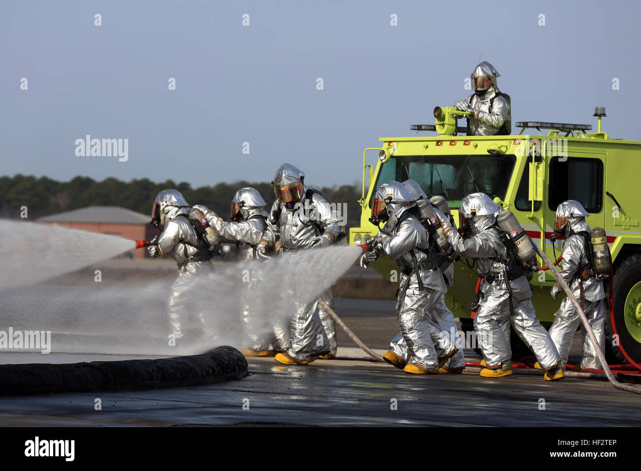 Aircraft rescue and firefighting Marines advance toward a controlled ...