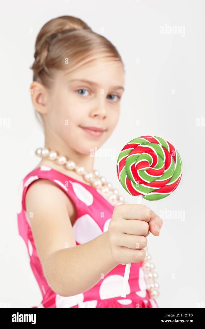 Girl shows a beautiful large candy Stock Photo - Alamy