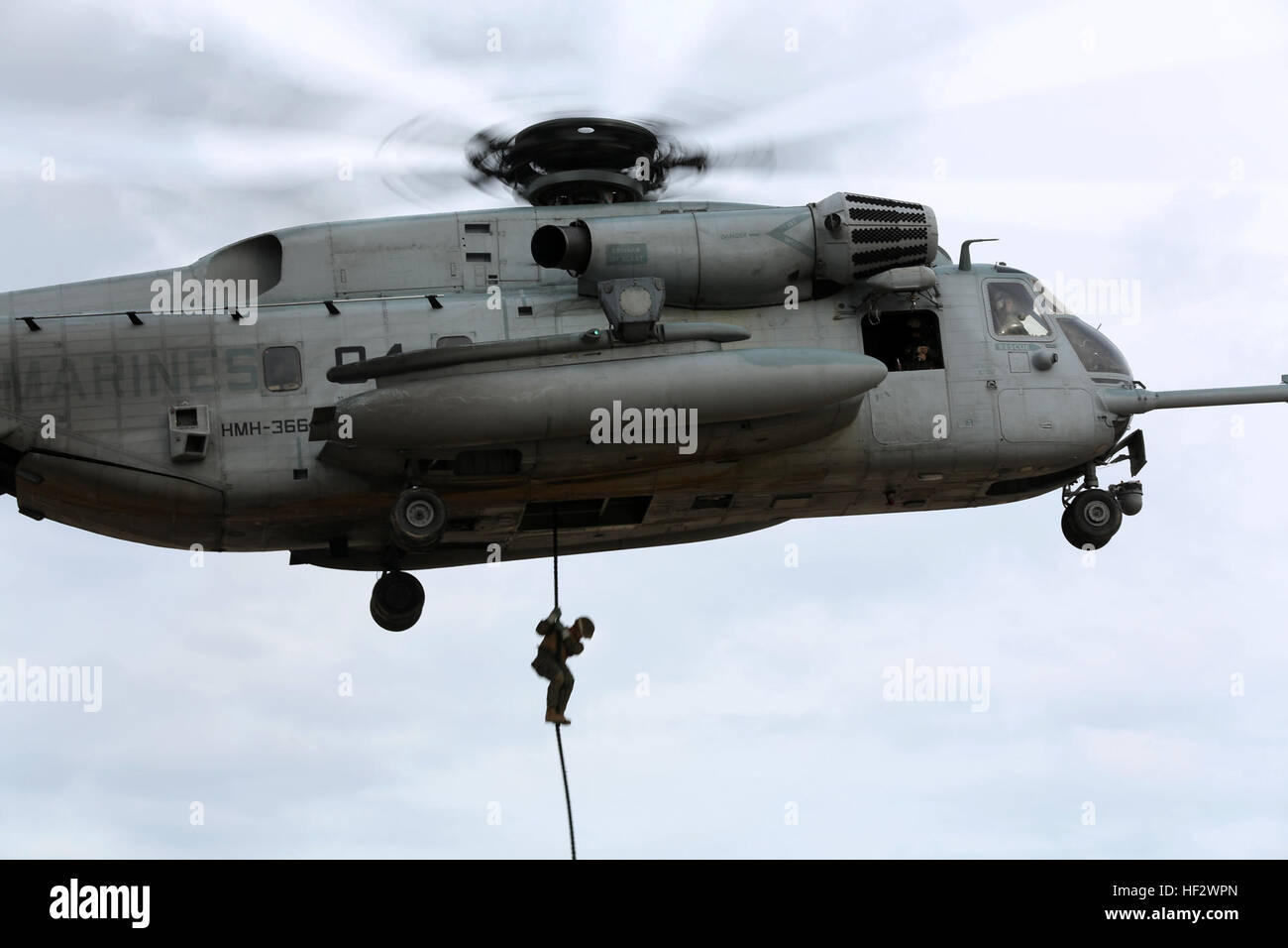A Marine with Expeditionary Operations Training Group fast-ropes from a ...