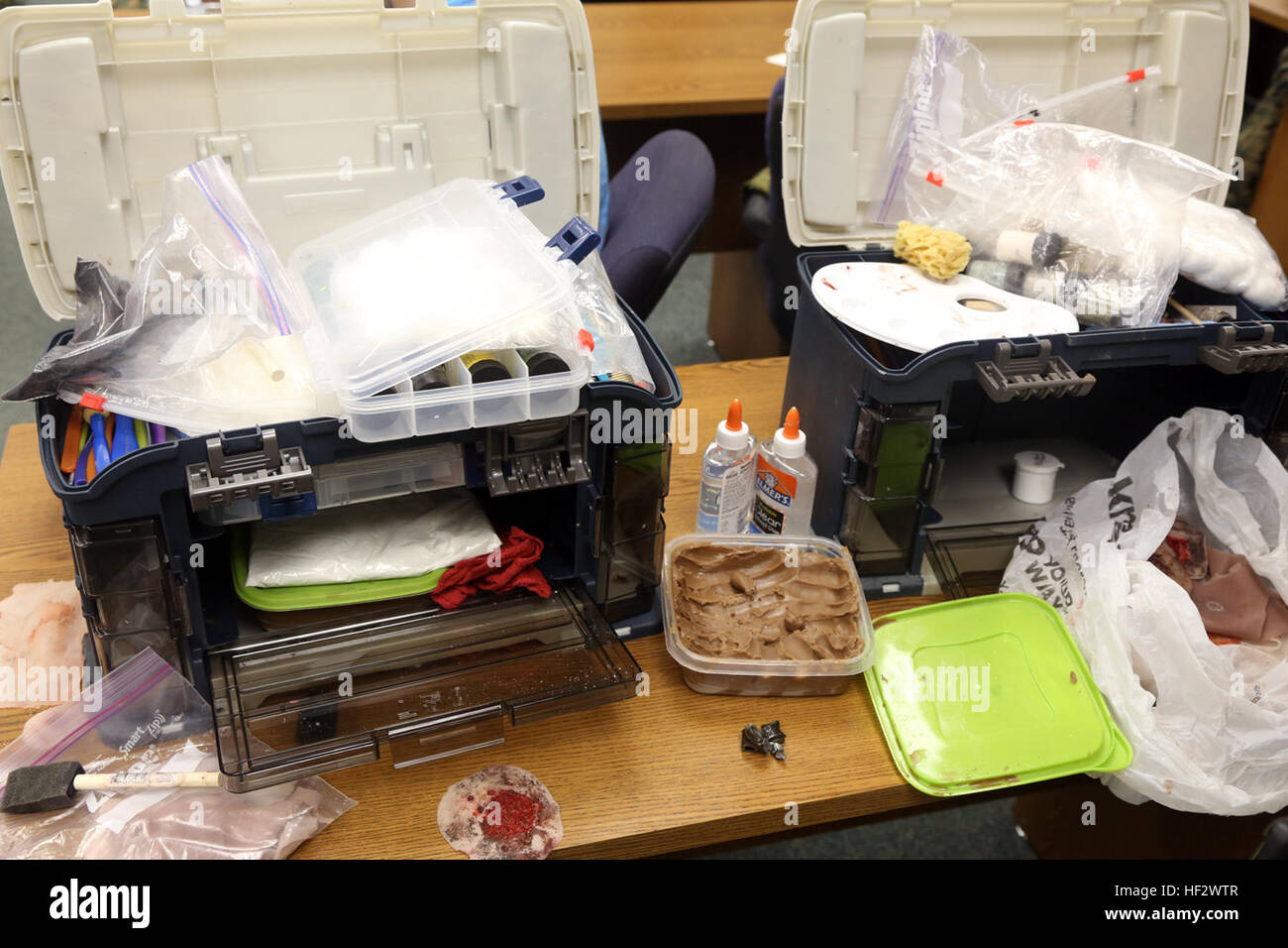 Two tackle box containing makeup and visual effect gear are staged and ...