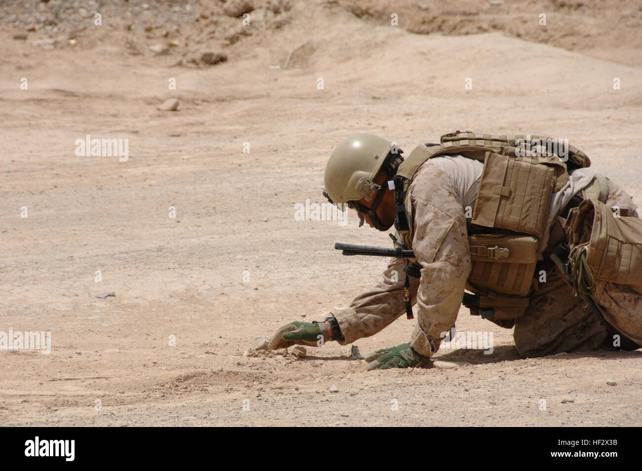 A coalition explosives ordinance disposal team find and disarm a bomb ...