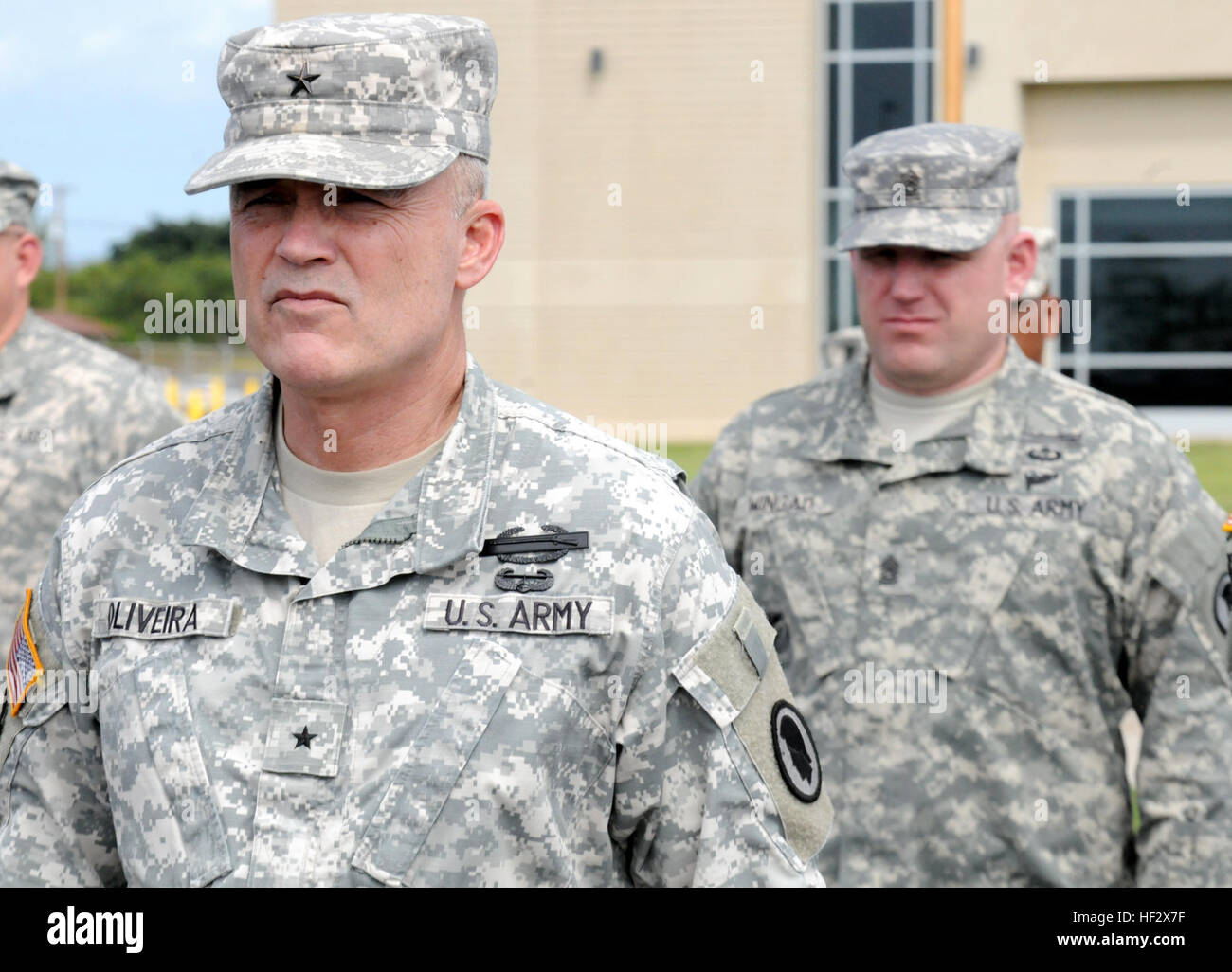 Brig. Gen. Bruce E. Oliveira stands at attention in front of the 29th ...