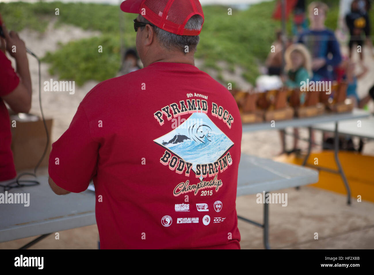 A volunteer of the 2015 Pyramid Rock Body Surfing Competition announces ...