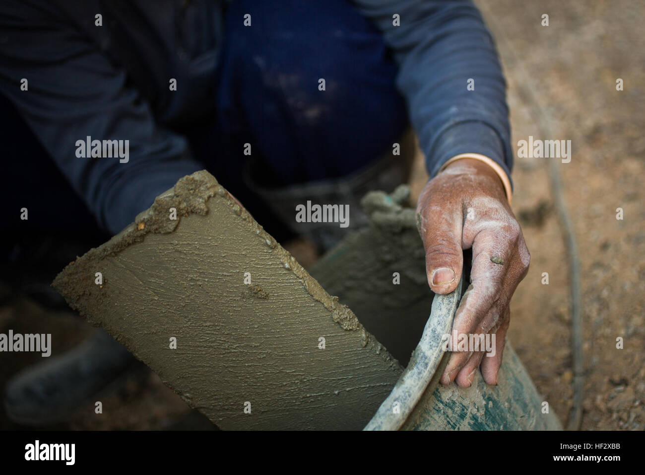 A soldier from the Royal Thai Air Force applies more plaster before ...