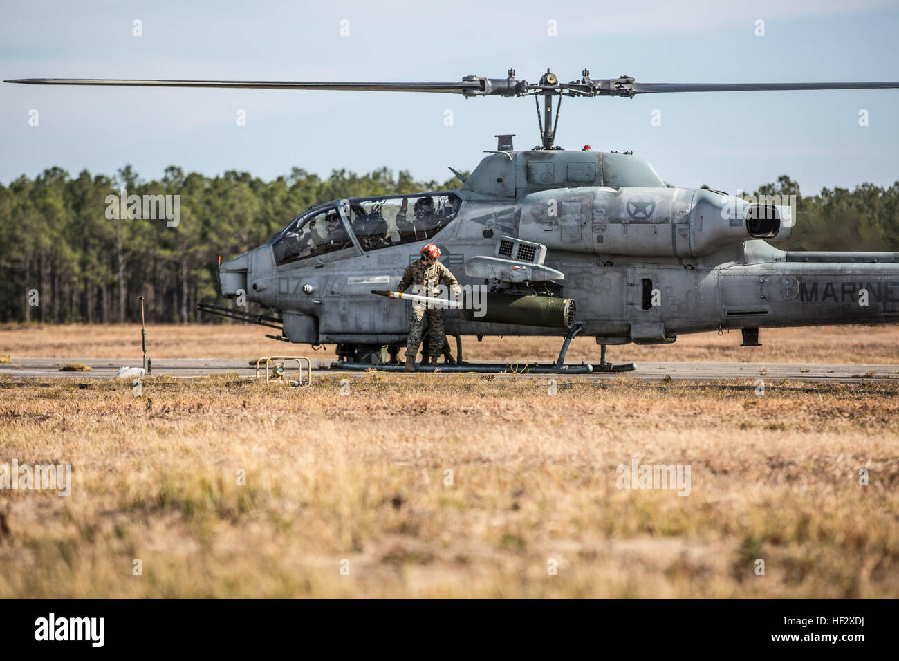 A U.S. Marine assigned to Marine Wing Support (MWSS) 274 loads an AH-1 ...