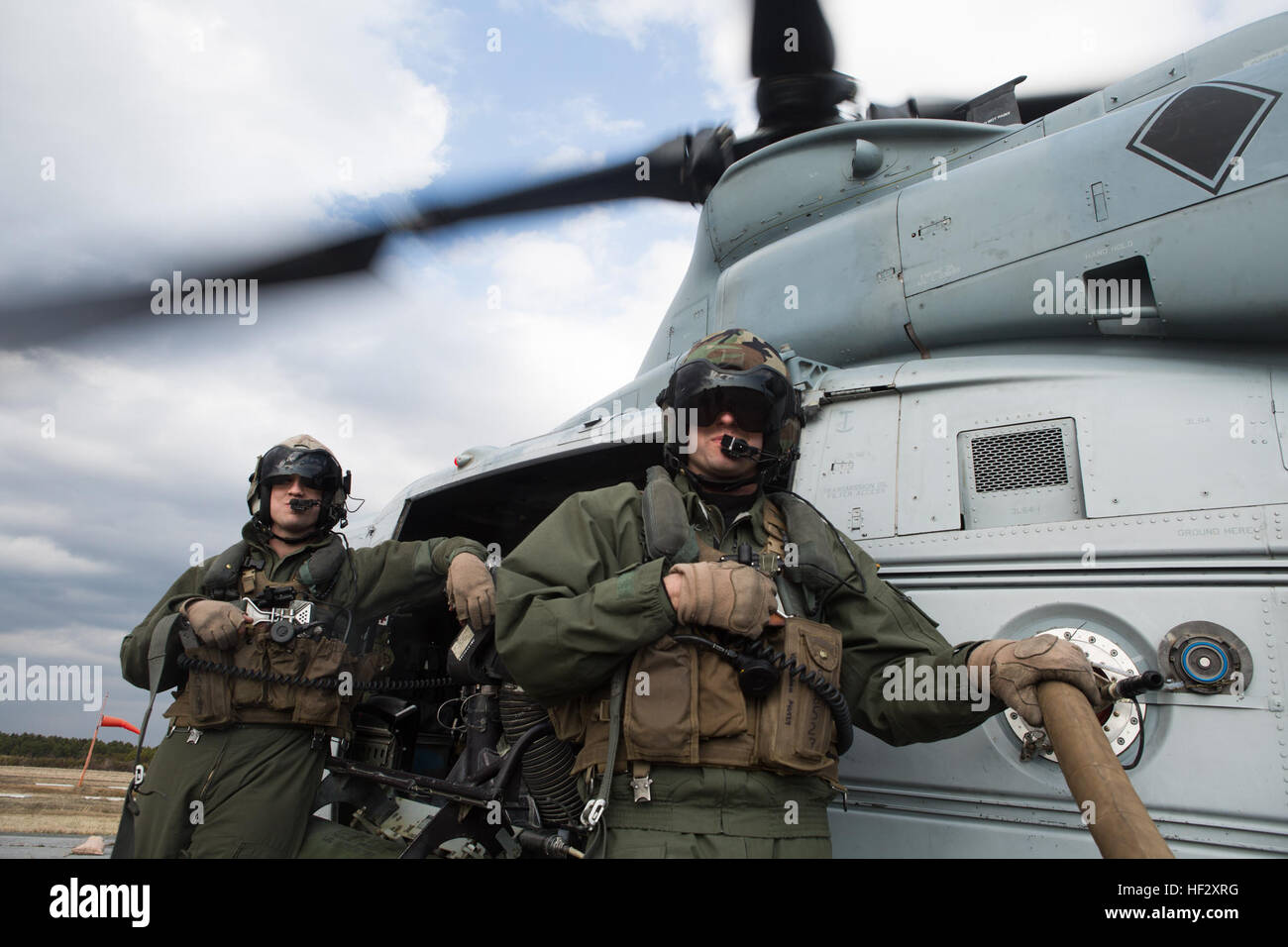 Two crew chiefs refuel their Bell UH-1Y Venom during Marine Wing ...