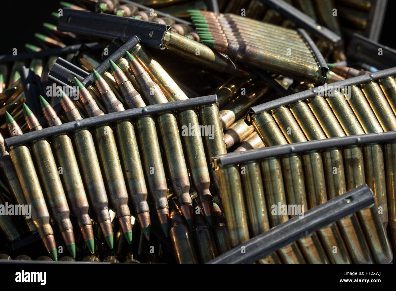 Clips of 5.56 mm ammunition lie in a bucket ready to be loaded into M16 ...