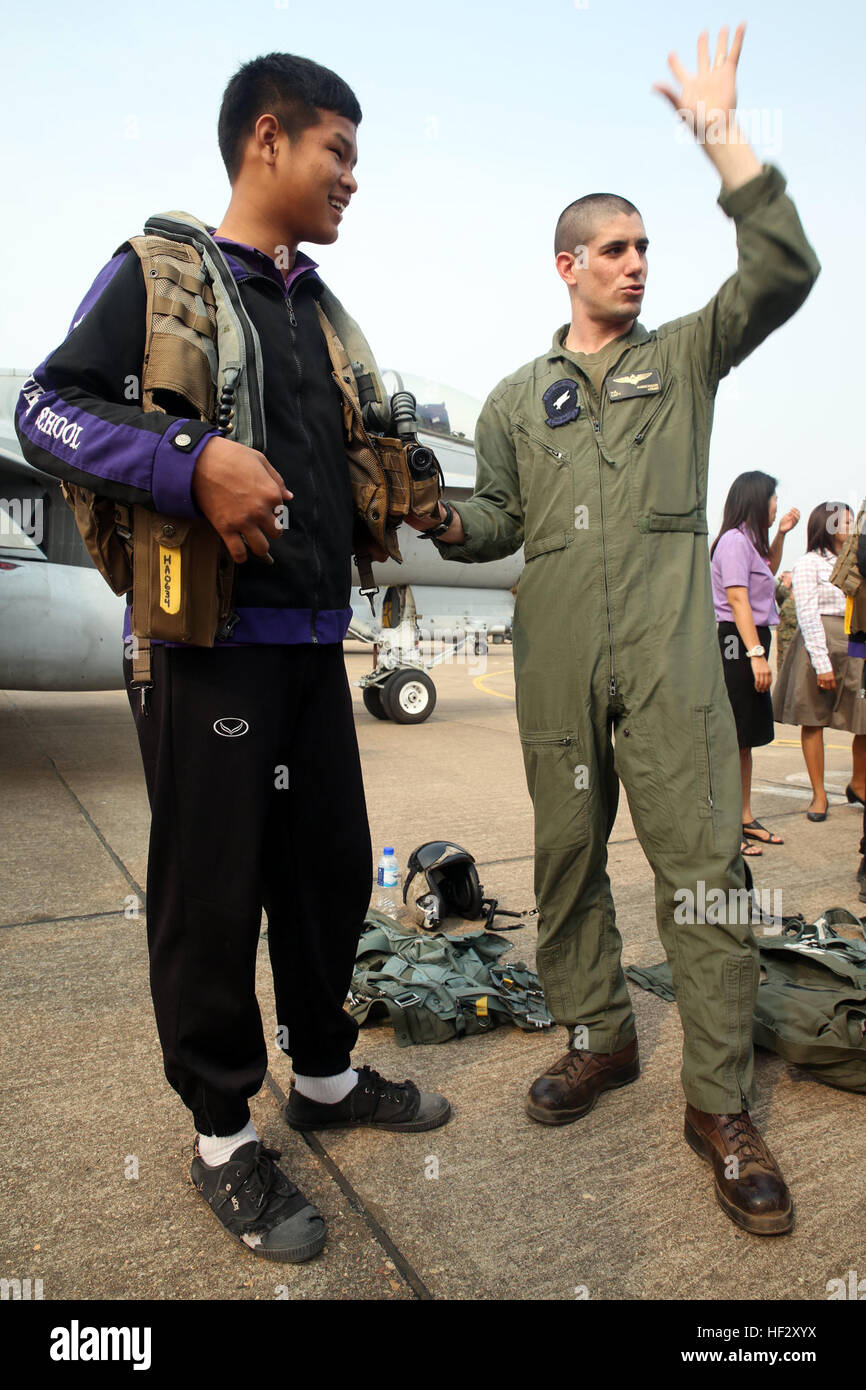U.S. Marine pilot Capt. Ernie Drake shows Yothinnukun School student ...