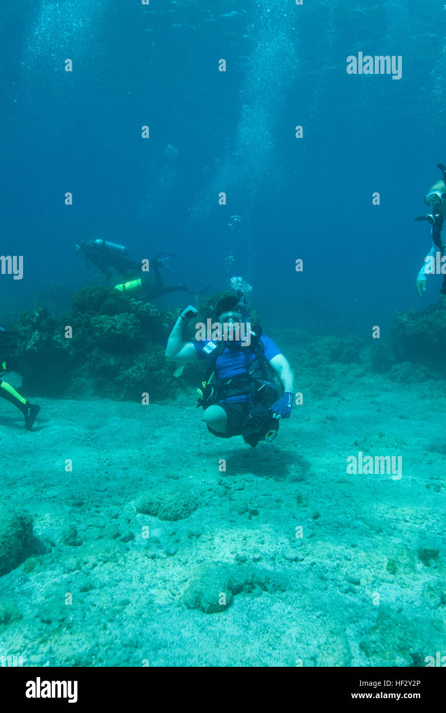 Retired Army Staff Sgt. Timothy Payne flexing his muscles during a dive ...