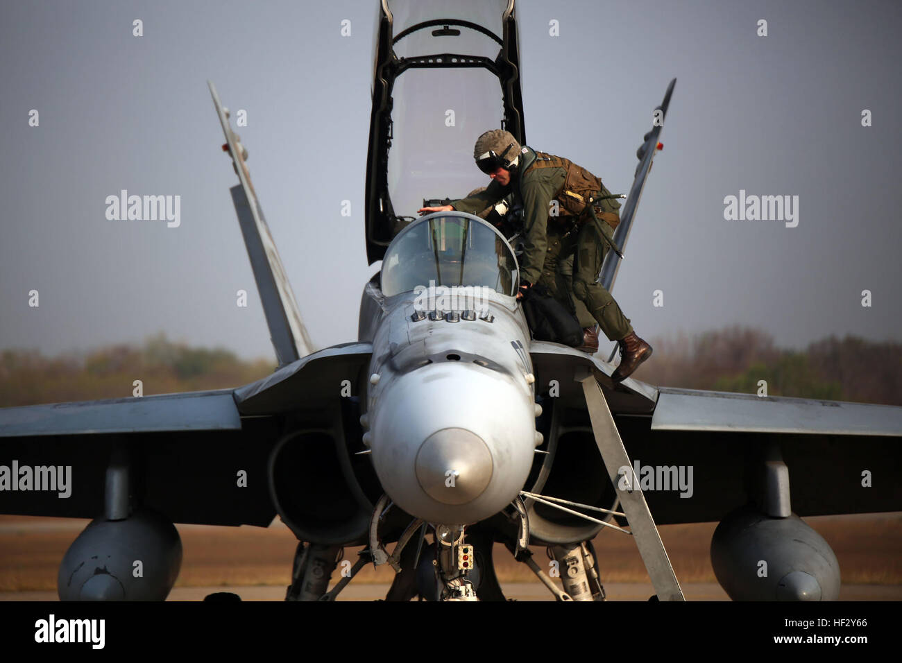 A U.S. Marine pilot enters the cockpit of an F/A-18 Hornet, Feb. 16. U ...