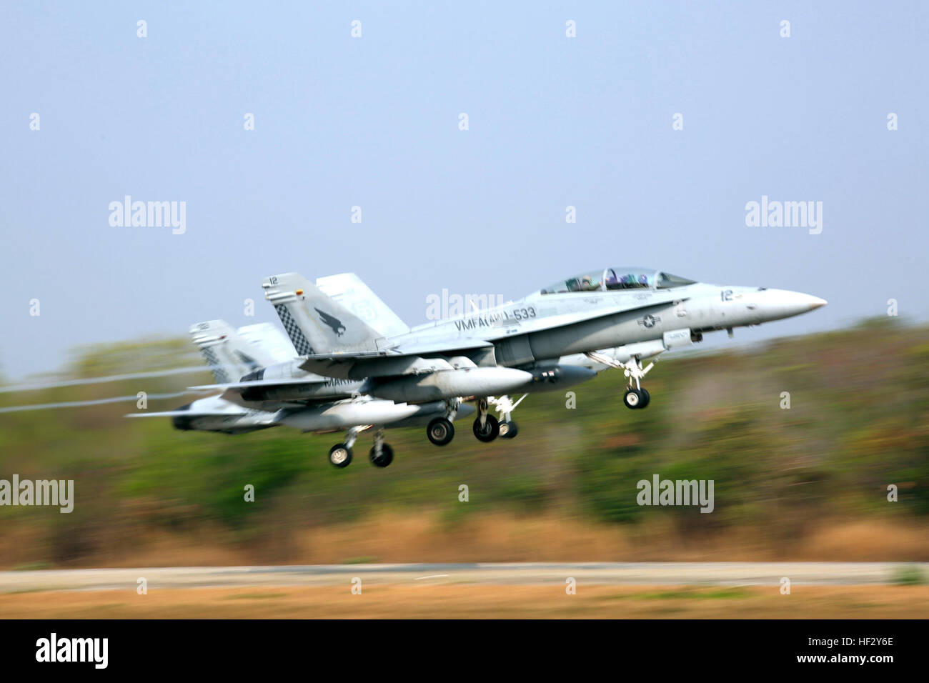 Two F/A-18 Hornets take off for flight during combined training with ...
