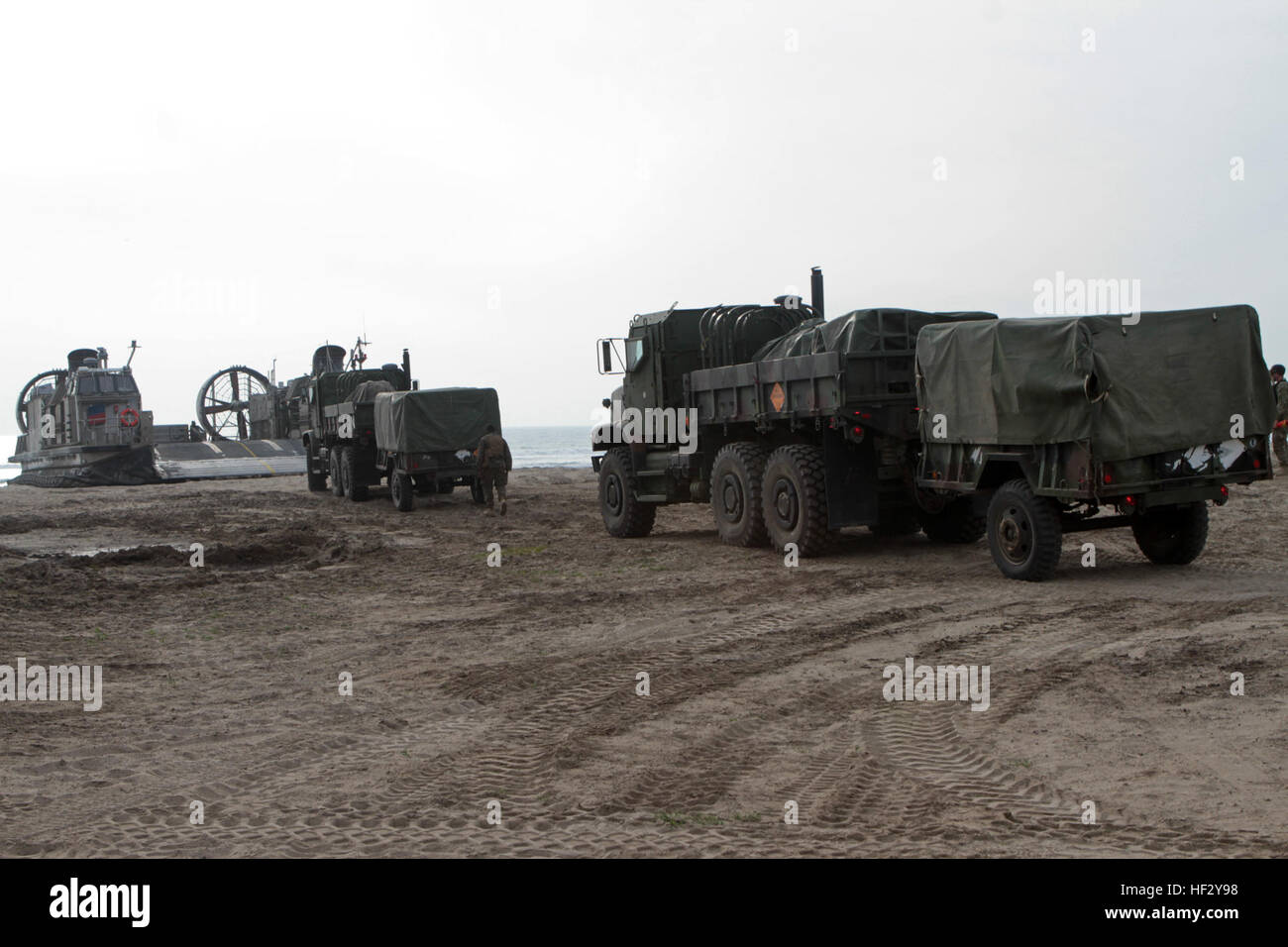 U.S. Marines load vehicles onto a U.S. Navy Landing Craft Air Cushion ...