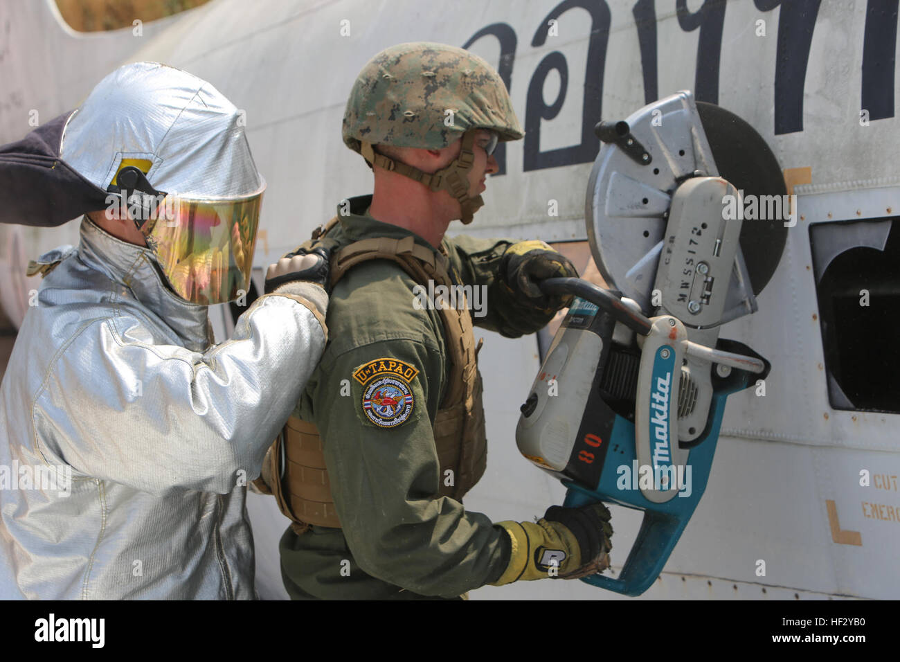 U.S. Marines demonstrate how to properly cut emergency evacuation holes ...