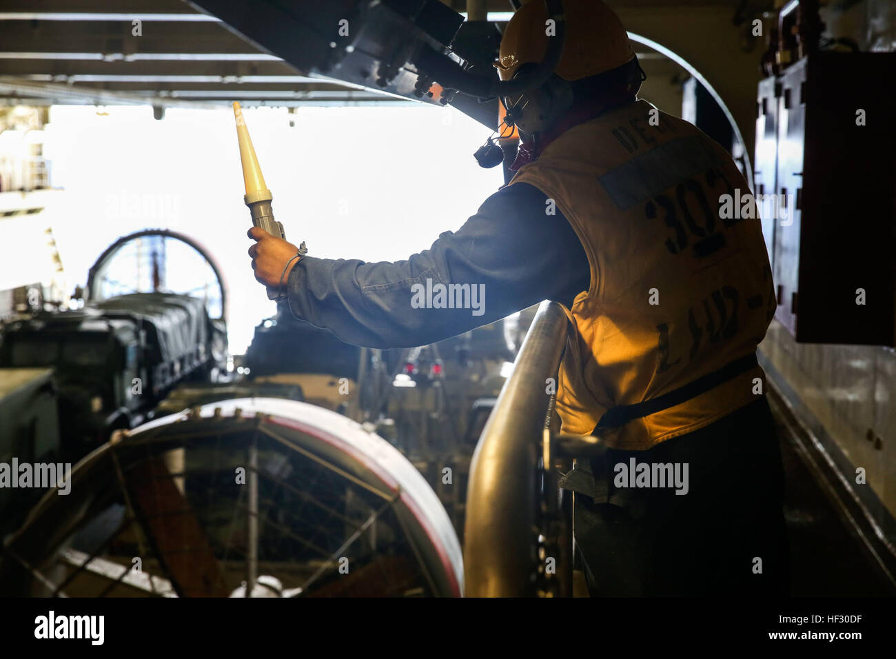 A U.S. Navy Sailor guides a landing craft, air cushion out of the well ...