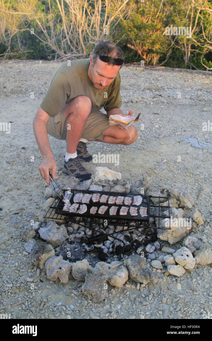 Bill Condon, the Boy Scout Committee chairman, cooks bacon while out ...